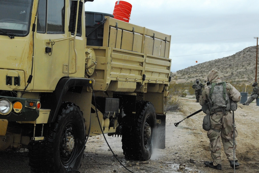 DVIDS - Images - Soldier sprays water to decontaminate truck [Image 1 of 4]
