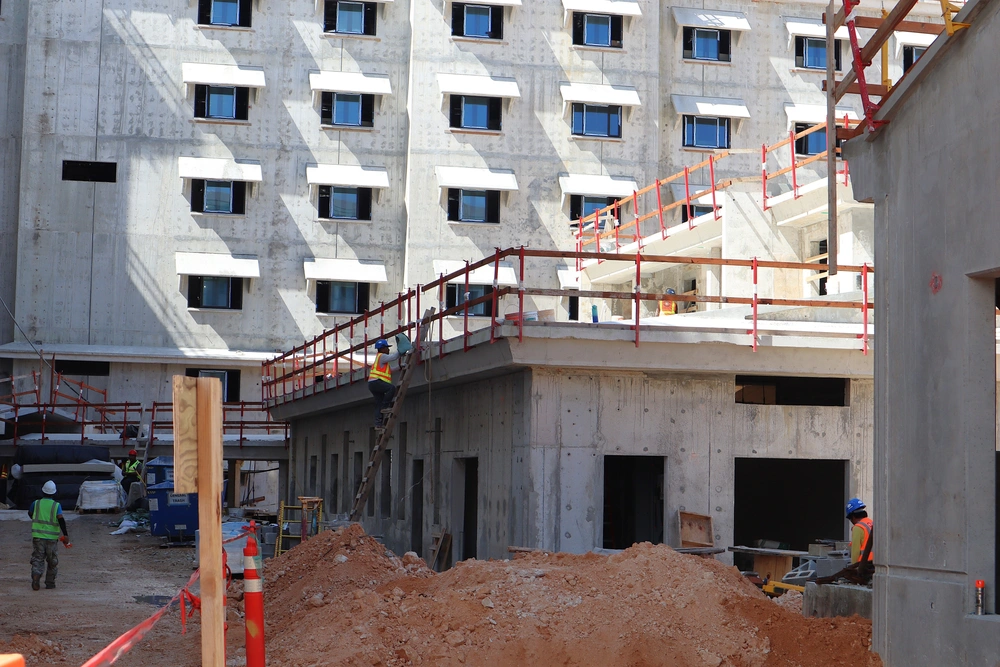 DVIDS - Images - Construction workers scale the walls of a central ...